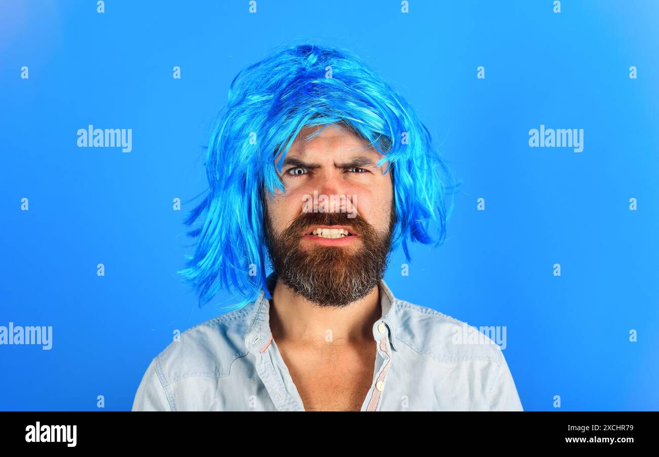 Angry man with beard and mustache in blue wig. Fashion concept ...