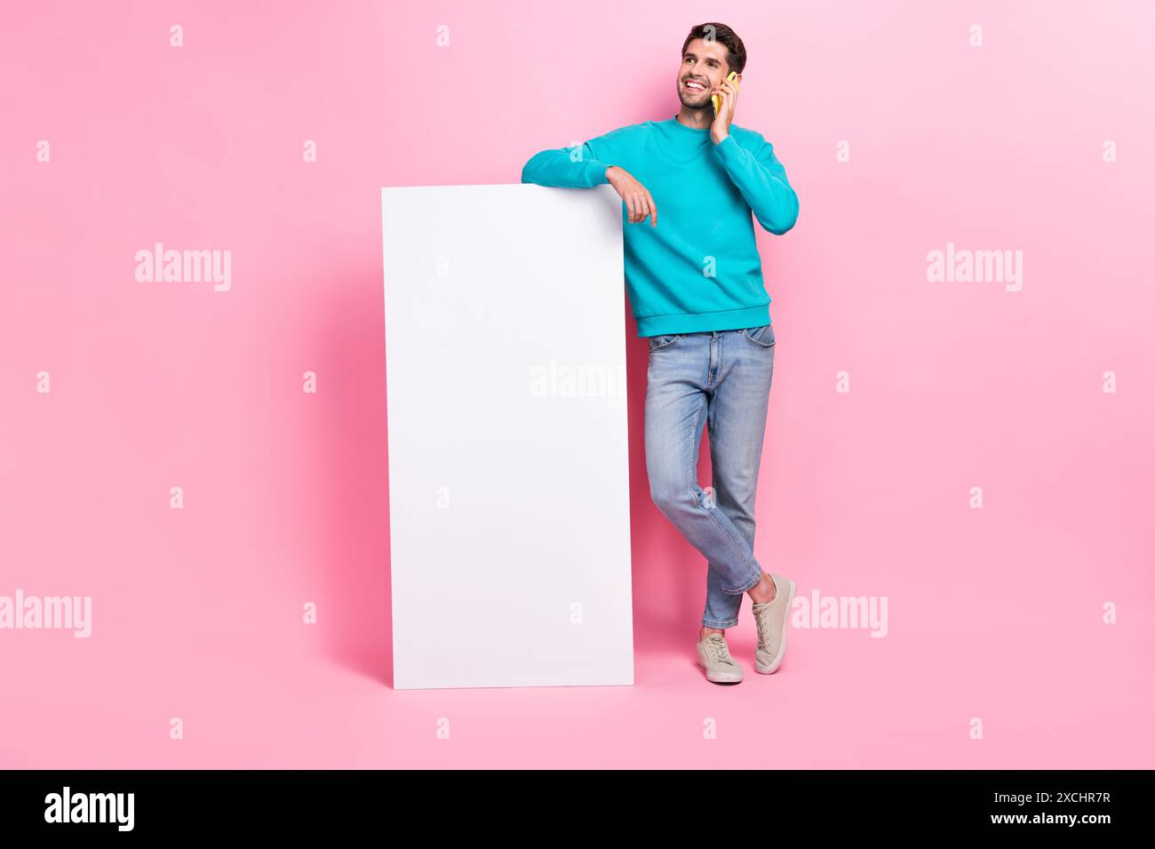 Full body photo of nice young man lean on vertical banner talk phone ...