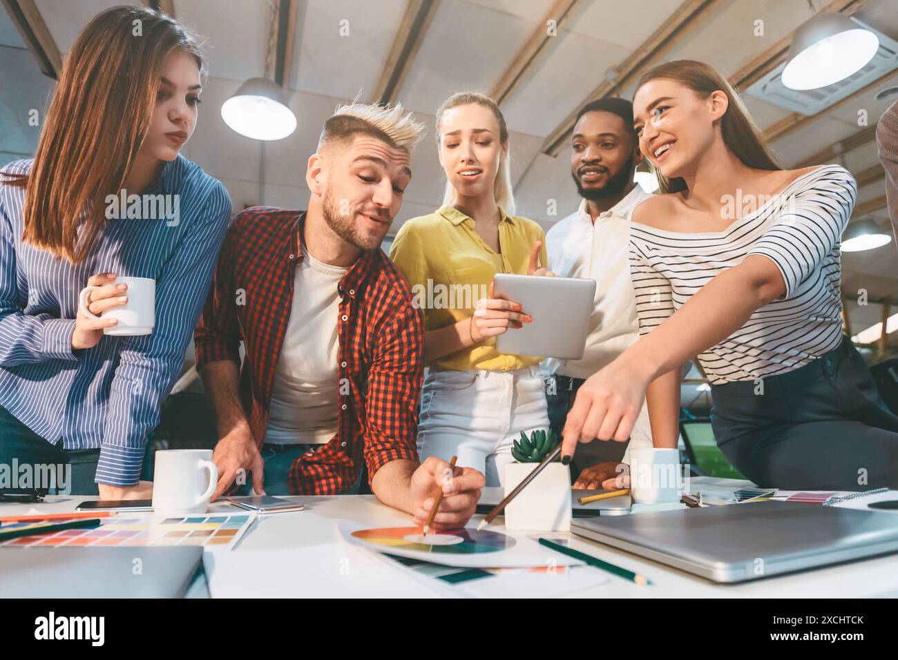 Creative Team Collaborates on Design Project in Modern Office During ...