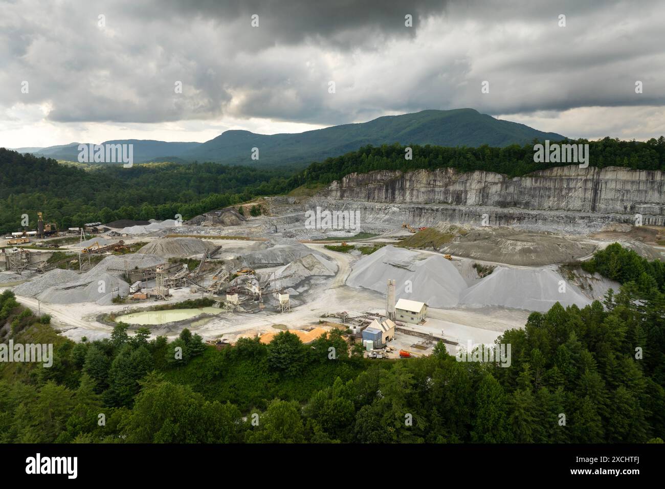 Aerial view of open pit mining site of limestone materials extraction ...