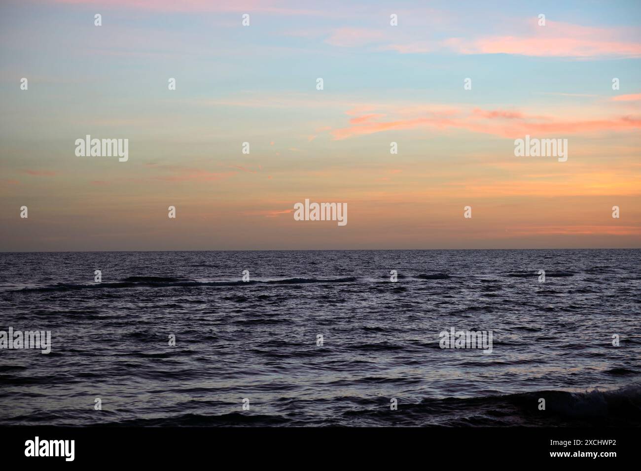 Dramatic red ocean waves at sunset with soft evening sea dark water ...