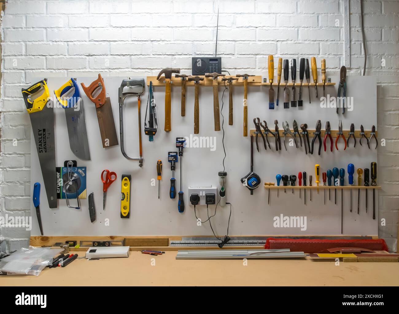 Tool rack over workbench Stock Photo - Alamy