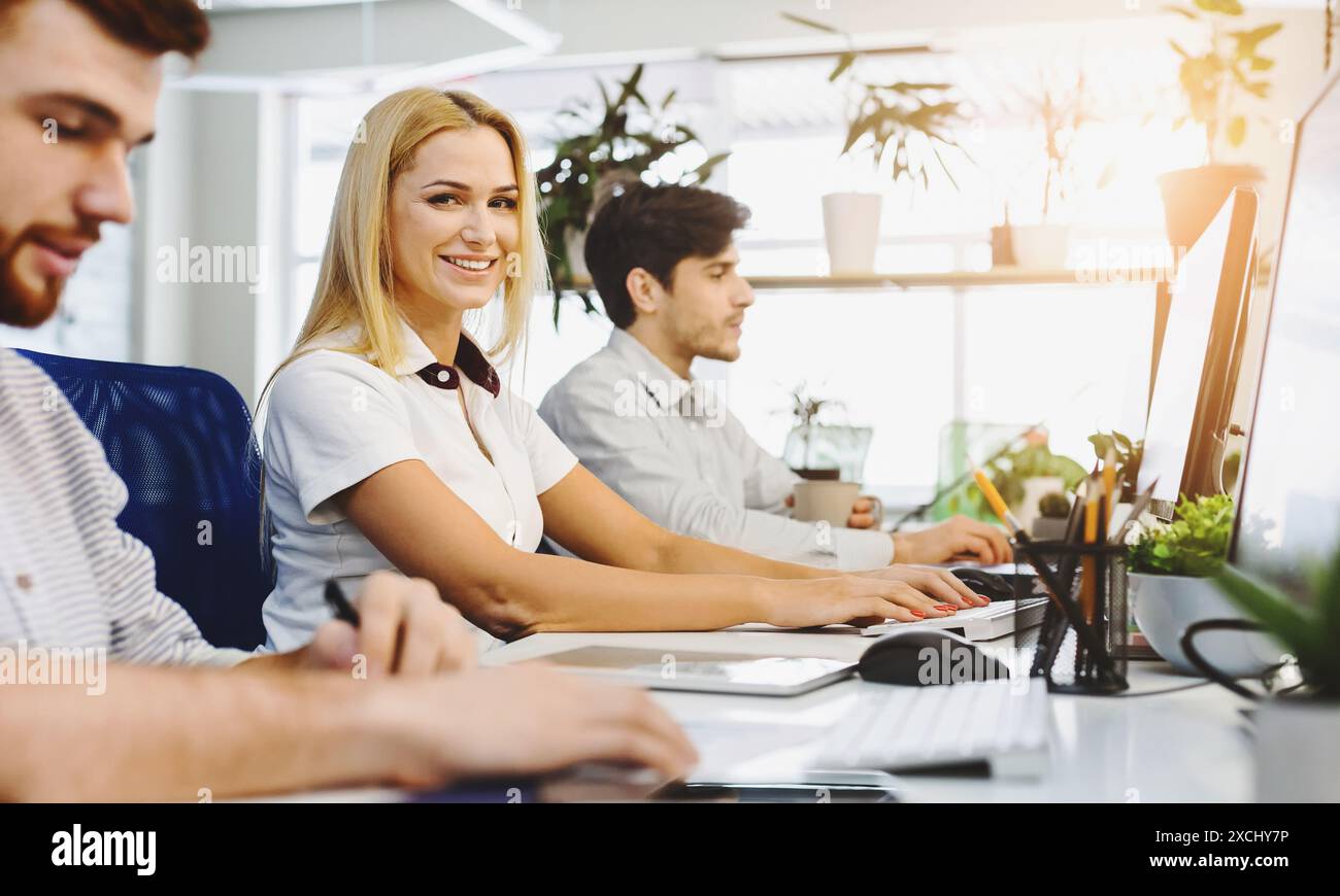 Group of People Working on Computers at Desk Stock Photo - Alamy