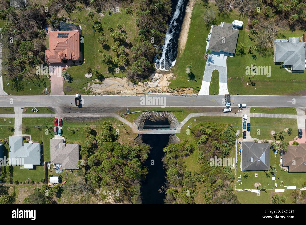 Road construction. Trucks blocking car access at destroyed bridge after ...