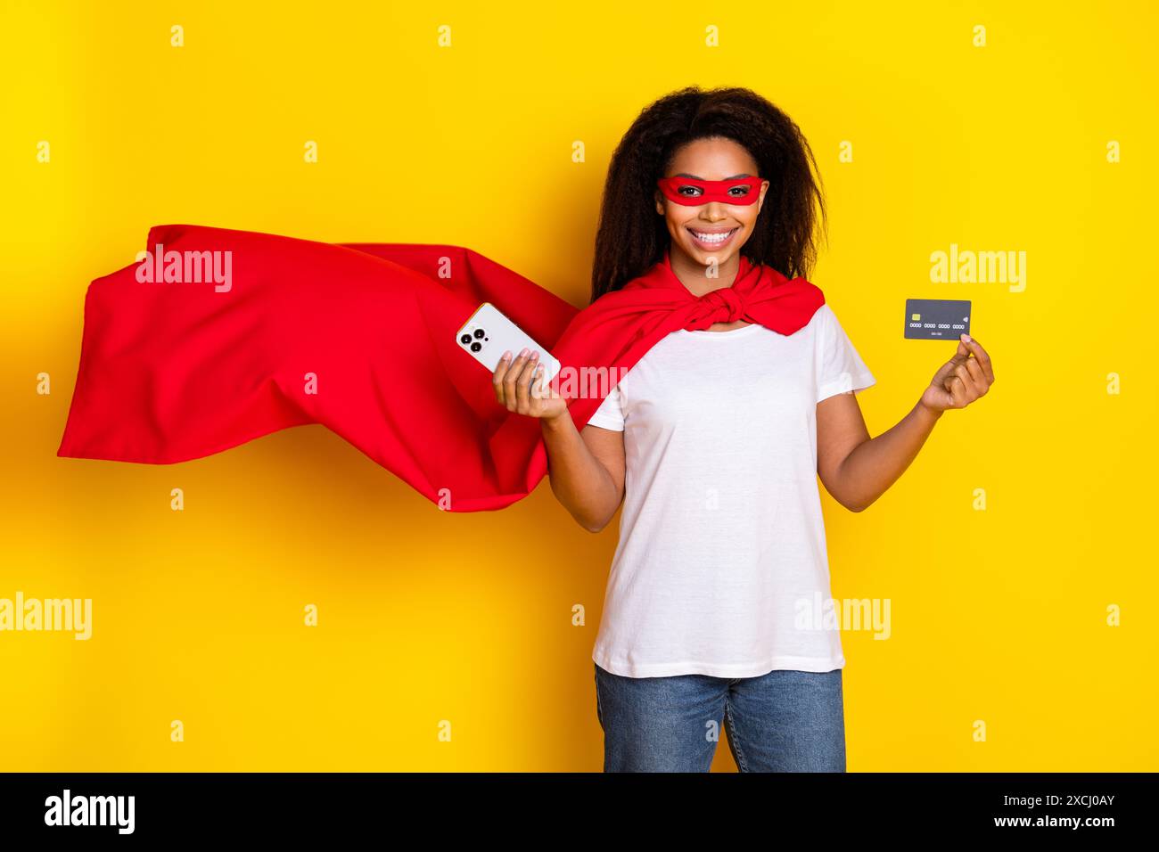 Portrait of nice young woman superhero costume smart phone debit card ...