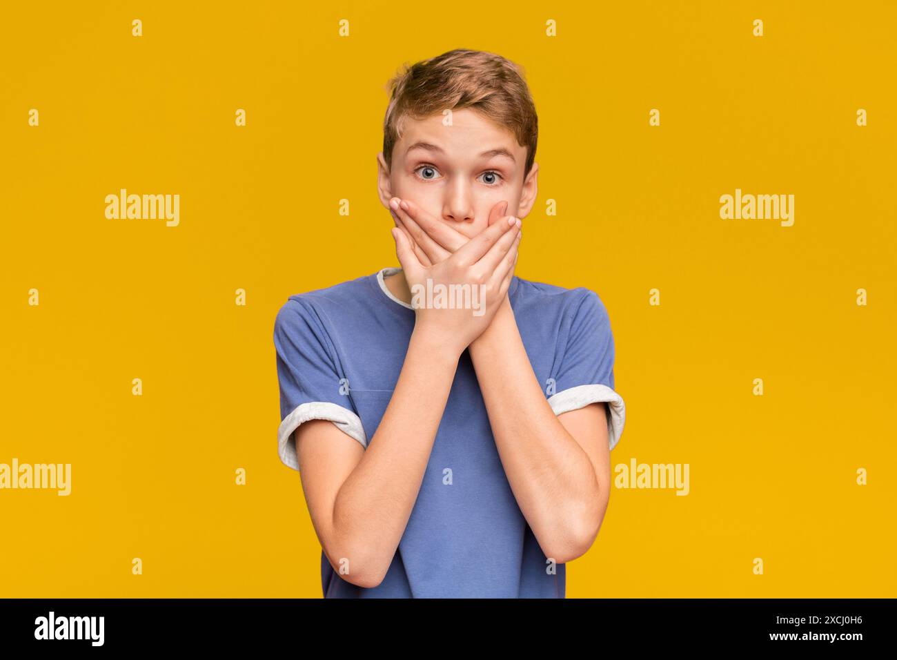 Portrait of stunned boy on orange studio background Stock Photo - Alamy