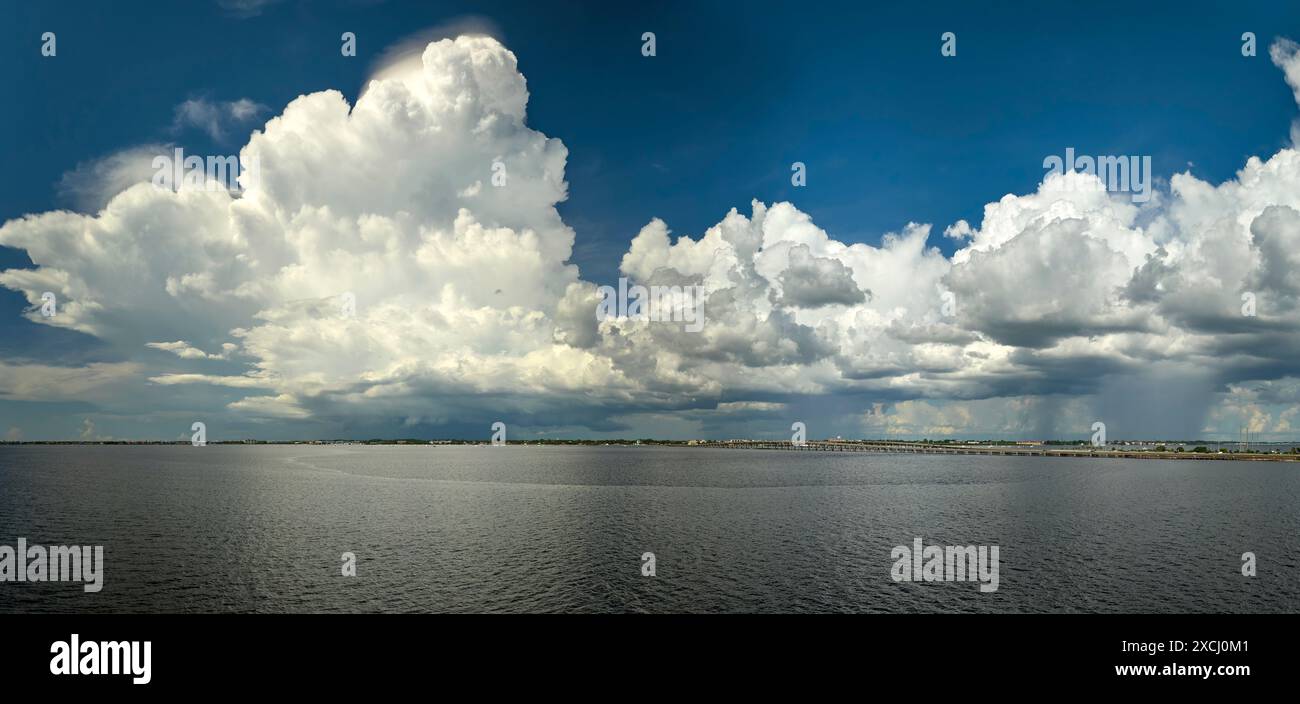 White fluffy cumulonimbus clouds forming from evaporating humidity of ...