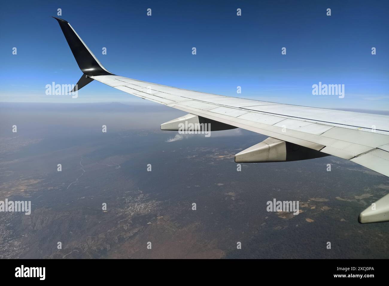 View through airplane window of commercial jet plane wing flying high ...