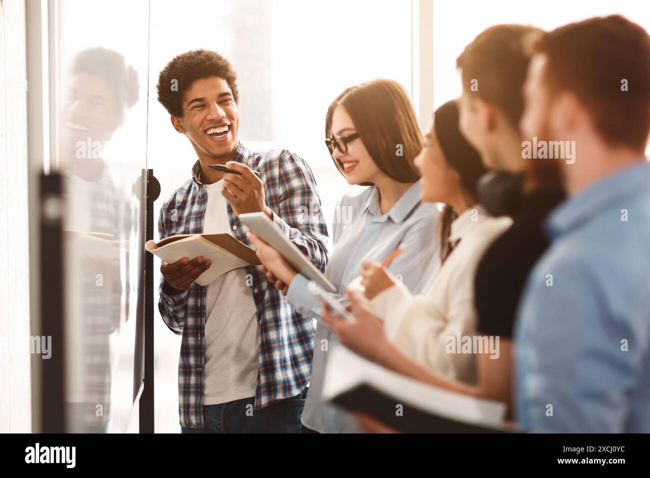 Students writing tasks on whiteboard in class Stock Photo - Alamy