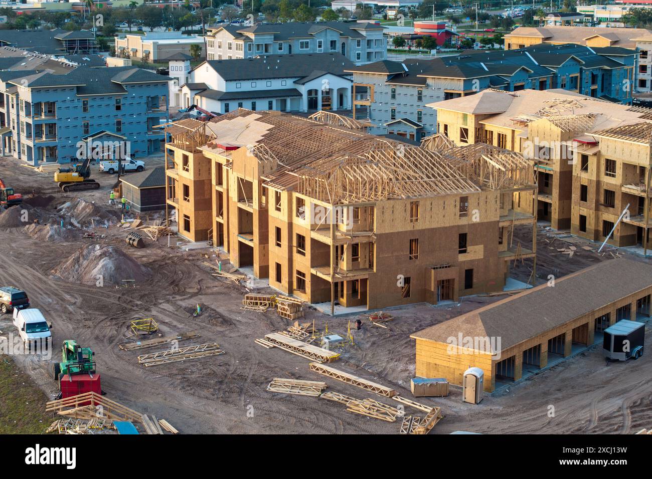 Wooden apartment buildings under construction in new developing ...