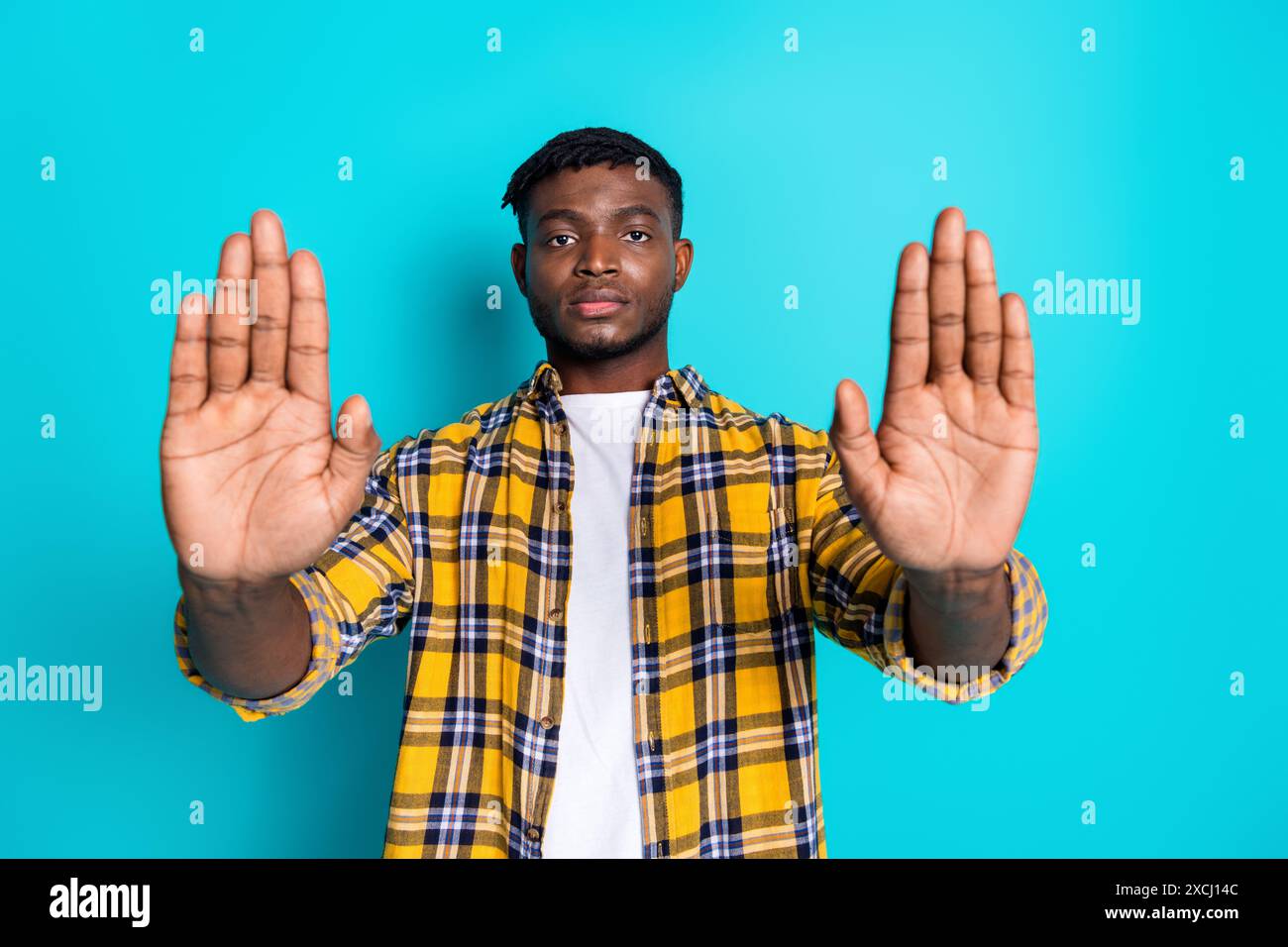 Photo of confident man wear trendy checkered clothes stop sign symbol ...