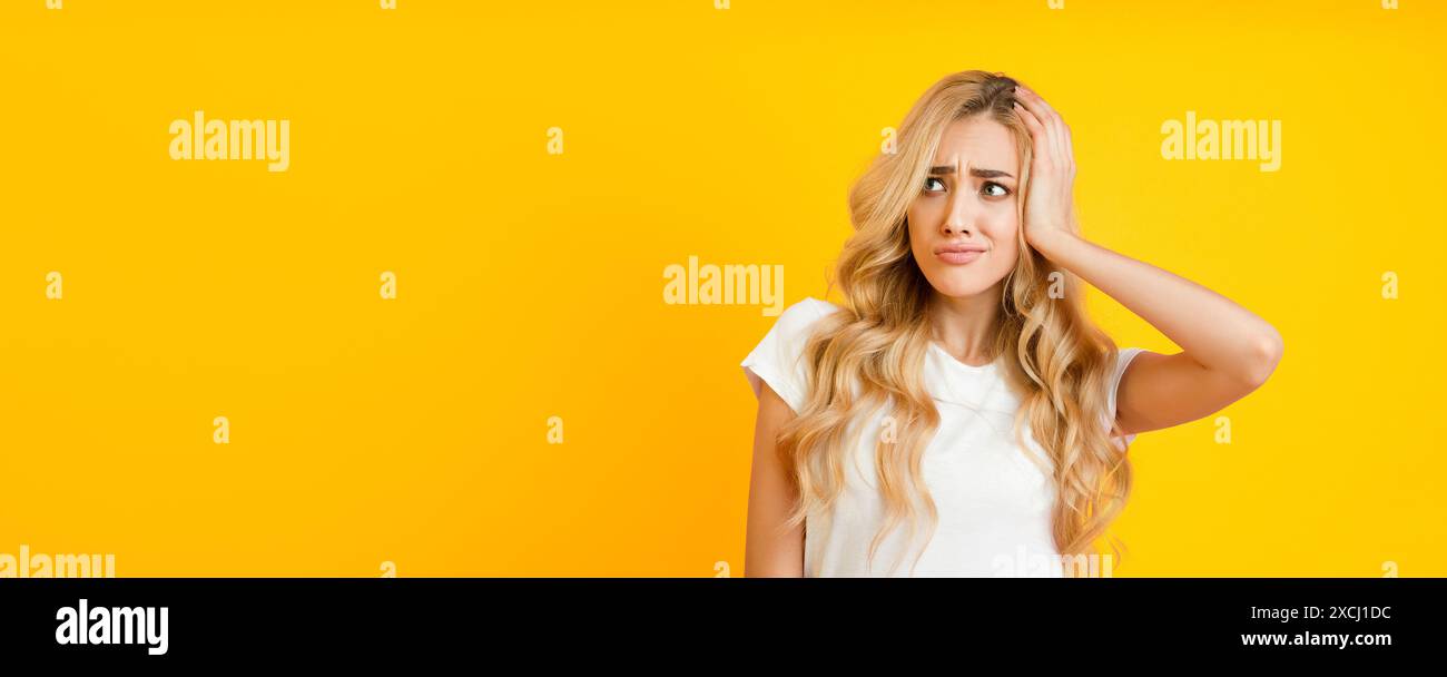 Young Woman In White Shirt Holding Head In Confusion Stock Photo - Alamy