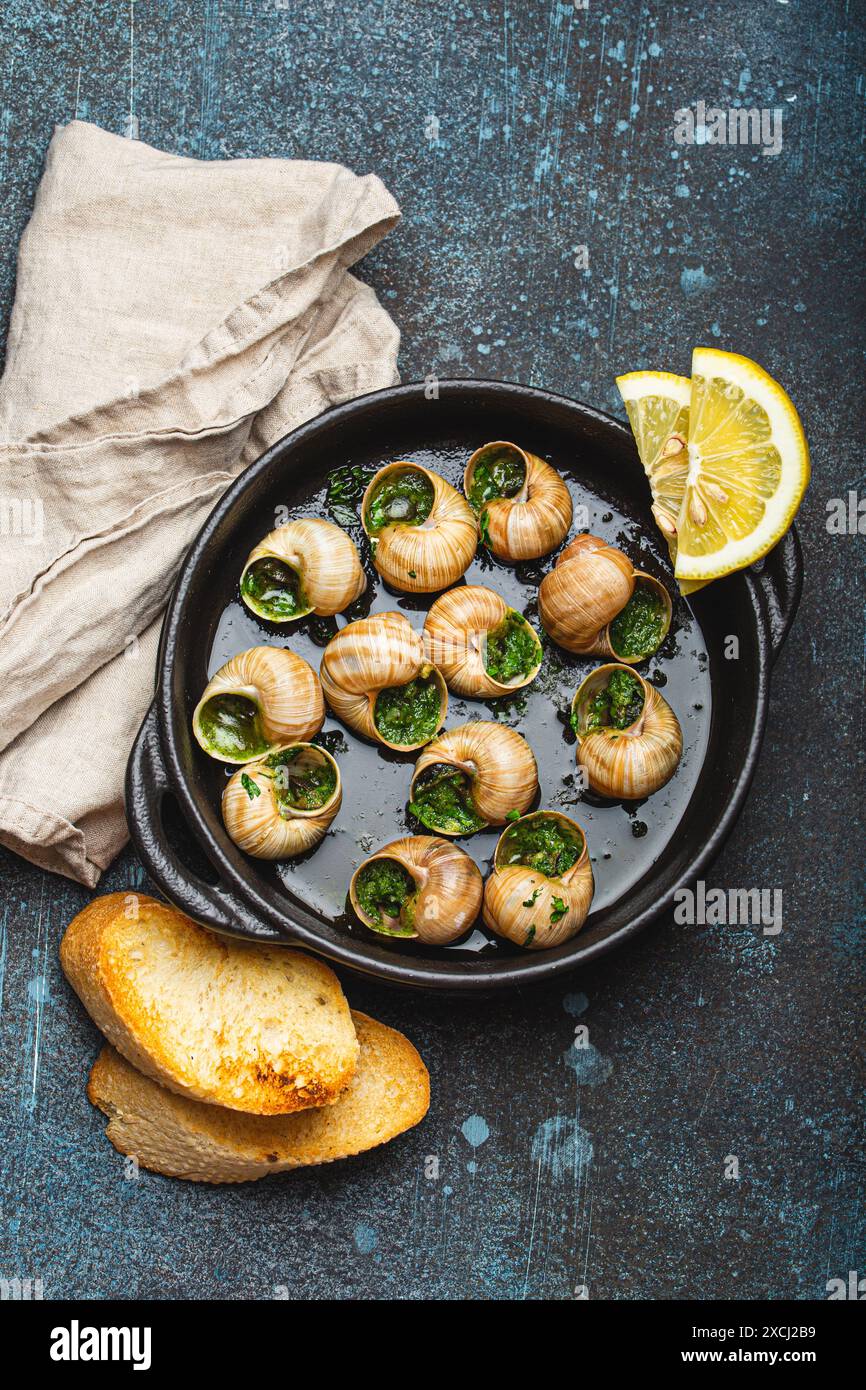 Escargots de Bourgogne Snails with Garlic Butter and Parsley in black ...
