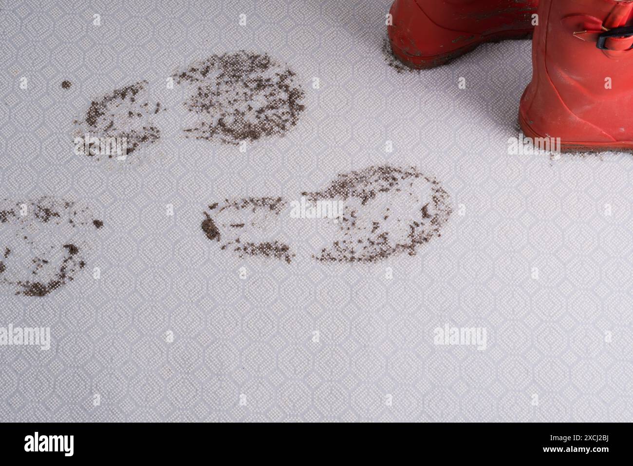Muddy carpet. Dirty footprints in wet mud, red shoes isolated on ...