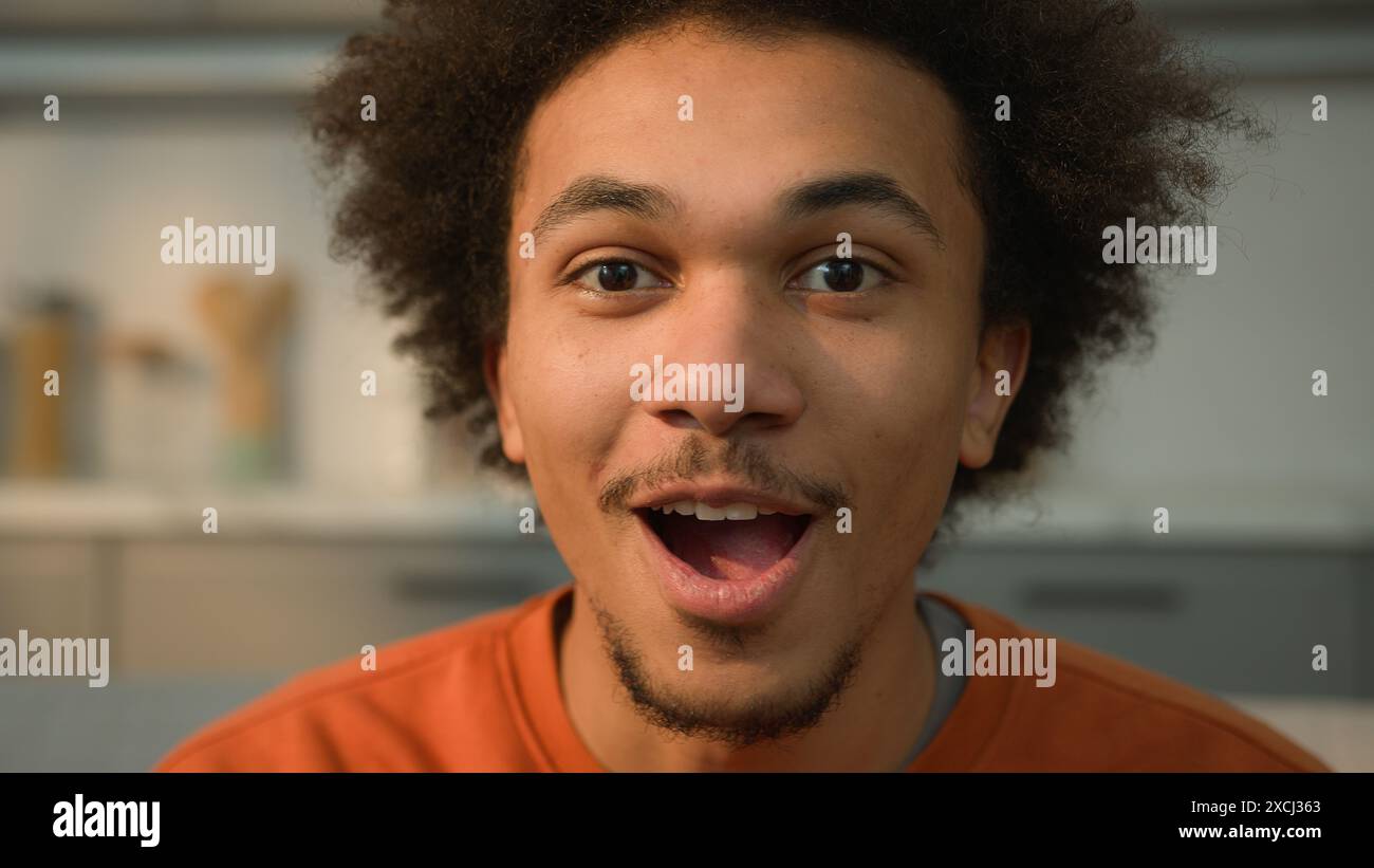 Close up happy excited African American man wonder male face surprised guy shocked amazed person ...