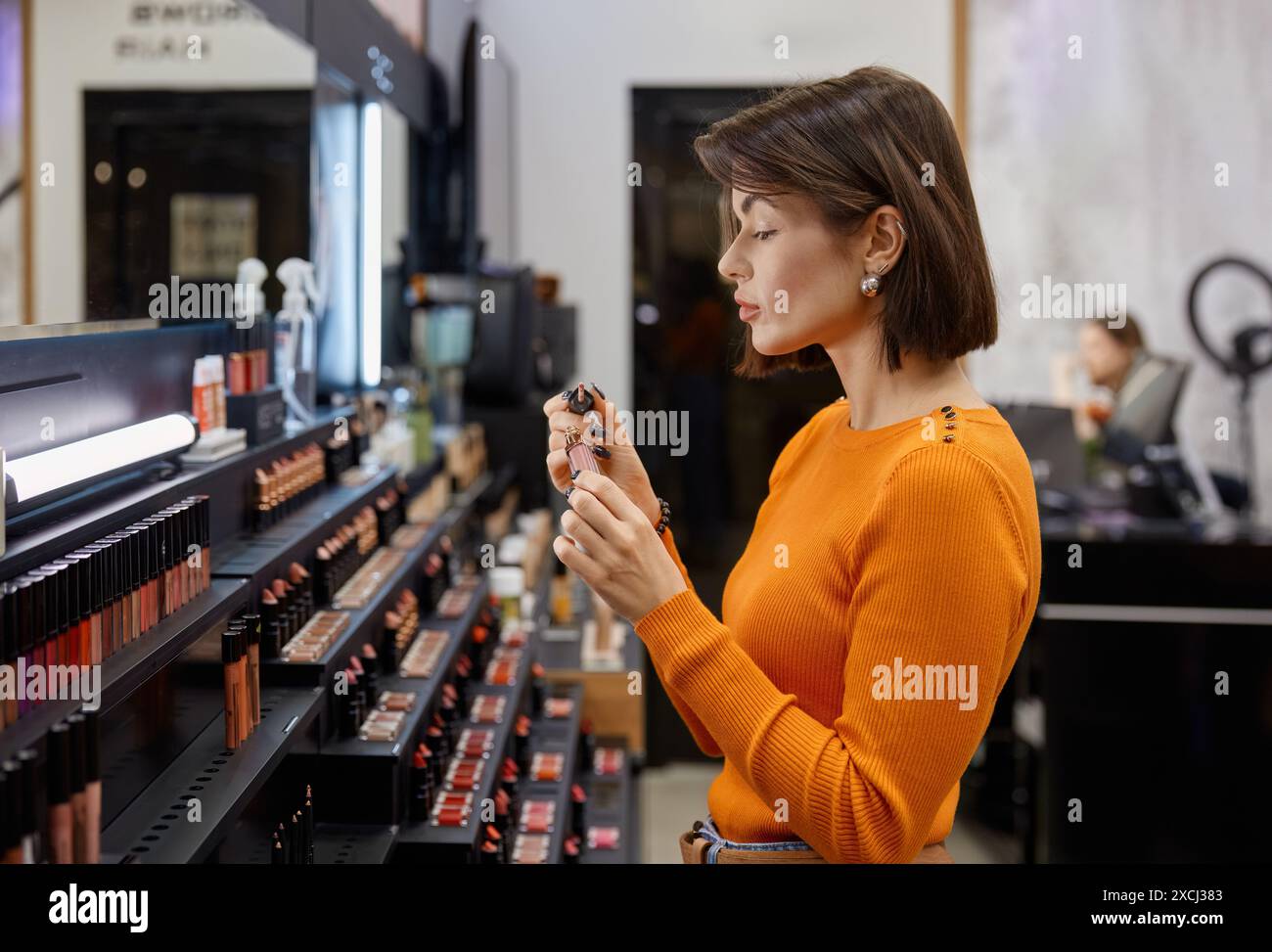 Young woman testing cosmetics in make-up store Stock Photo - Alamy
