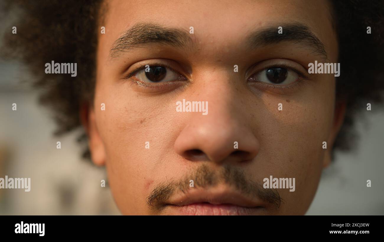 Extreme close up portrait African American ethnic guy male man looking ...
