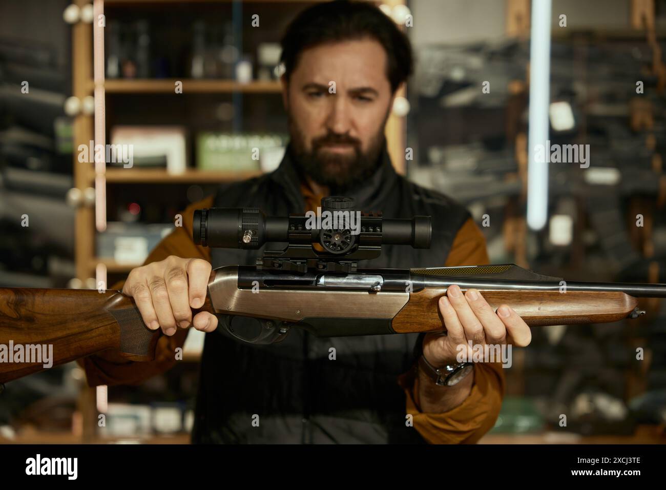 Mature man seller demonstrating gun standing at counter desk in weapon ...