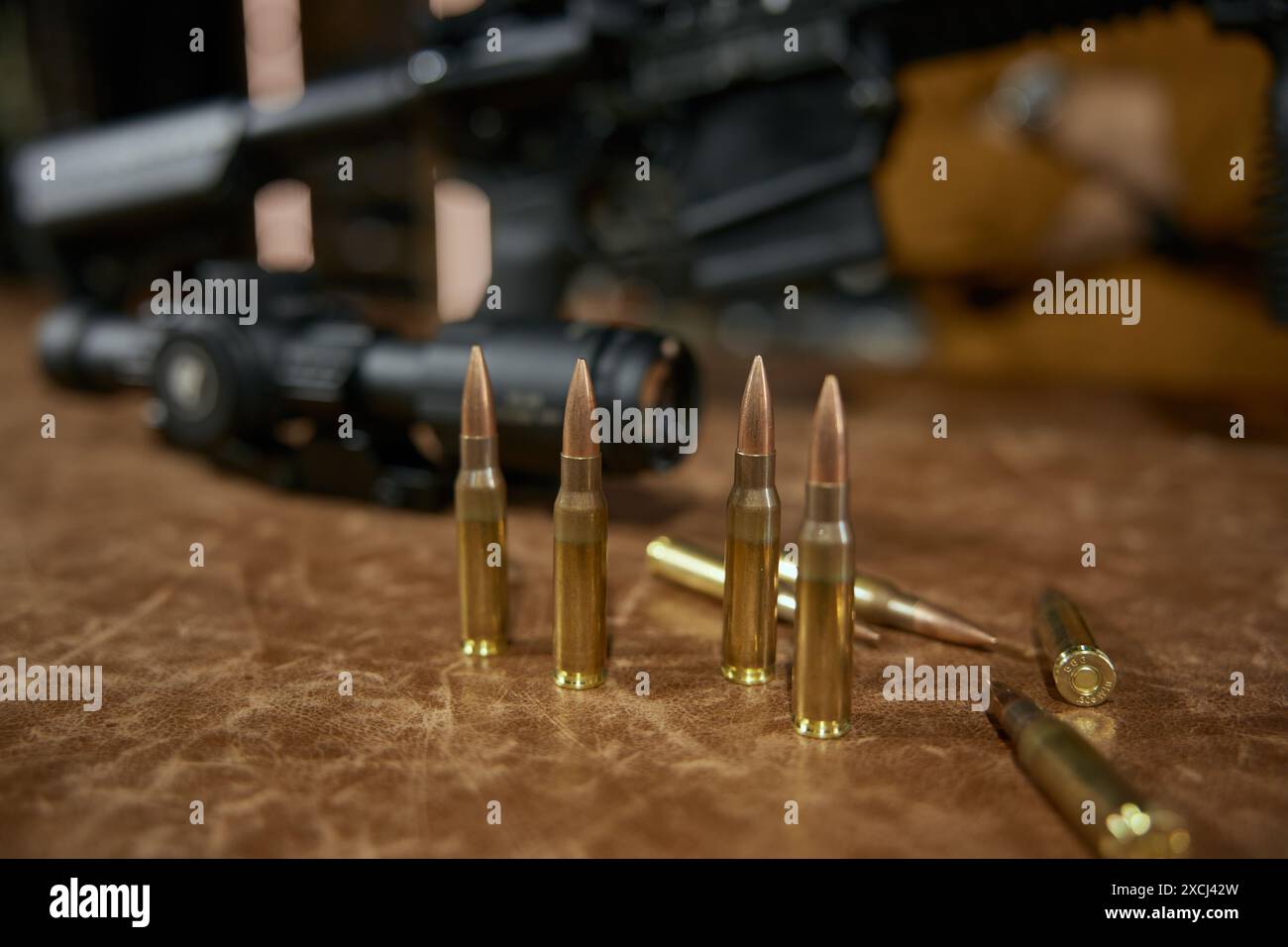 Automatic rifle and bullets at weapon store Stock Photo - Alamy