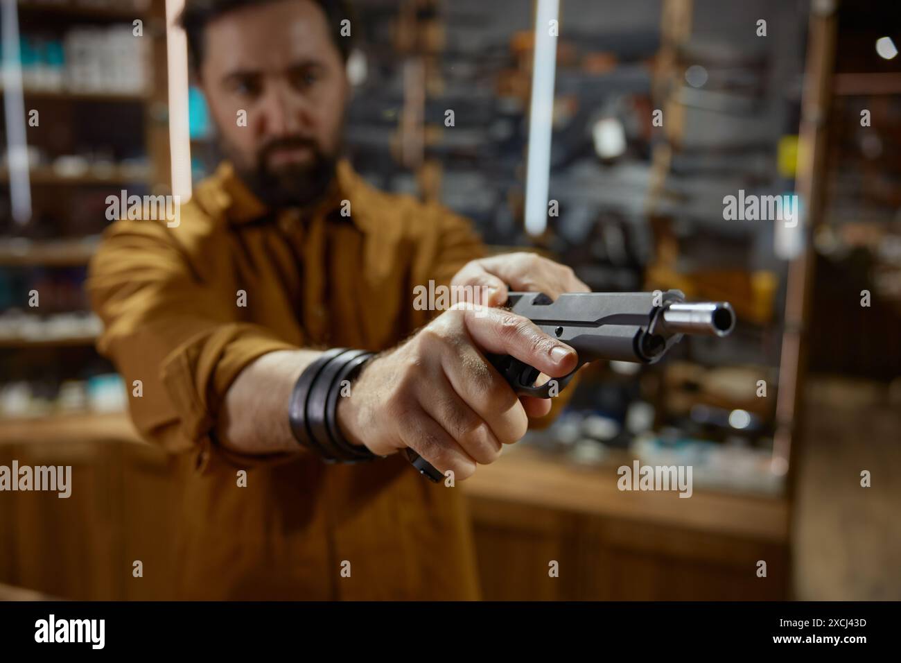 Hand holding gun store hi-res stock photography and images - Alamy