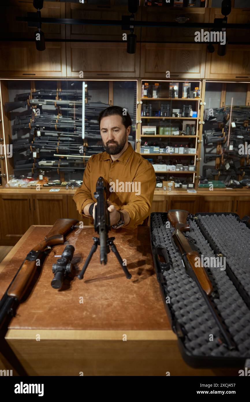 Experienced salesman showing new gun machine for clients Stock Photo ...