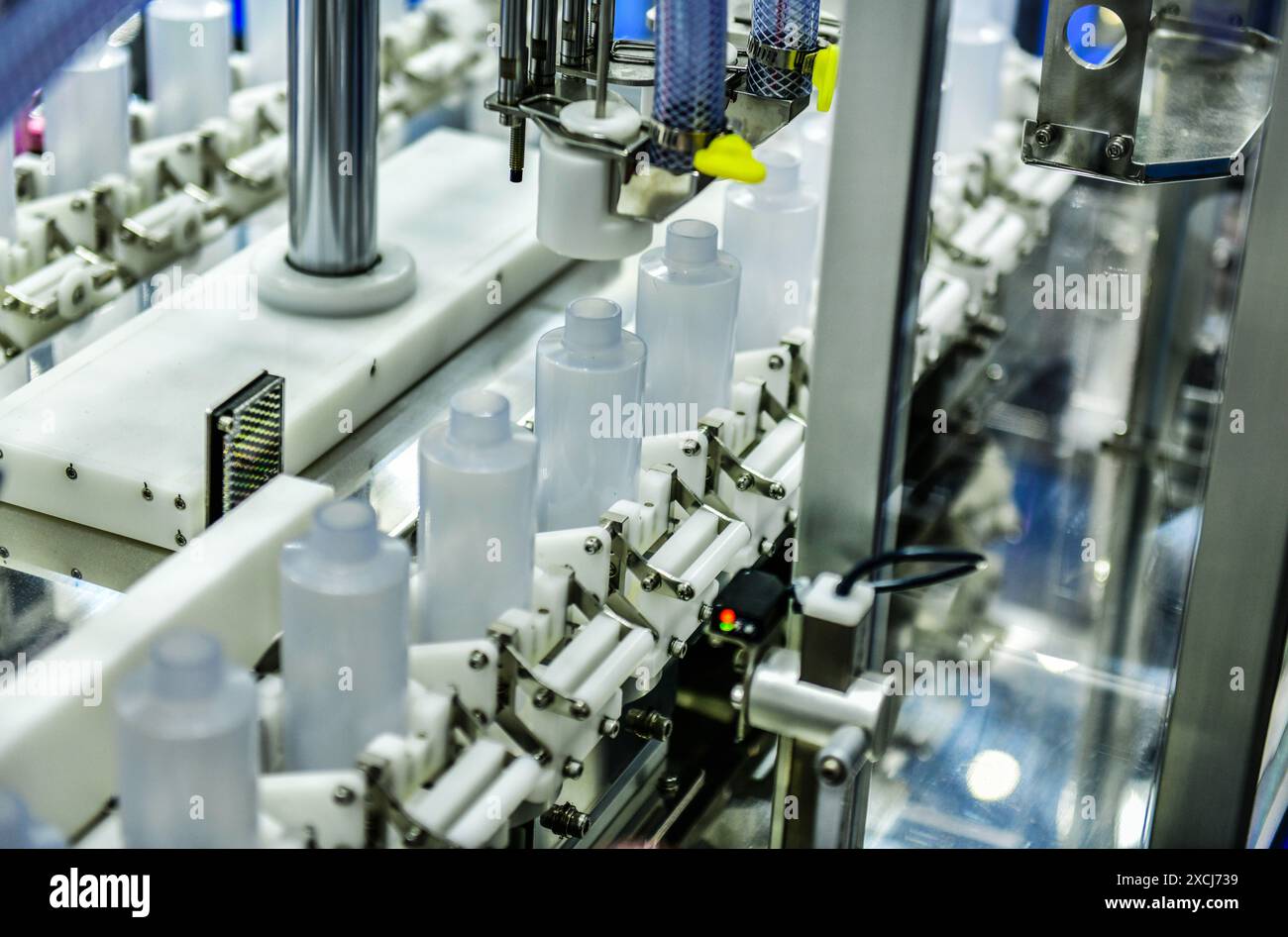White plastic bottles in a conveyor belt on a high quality automatic ...