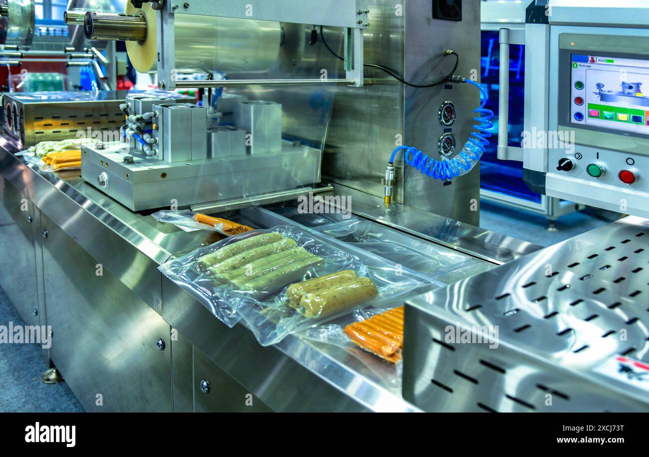 High-performance machines are wrapping processed fresh food products, pork, sausages.food ...