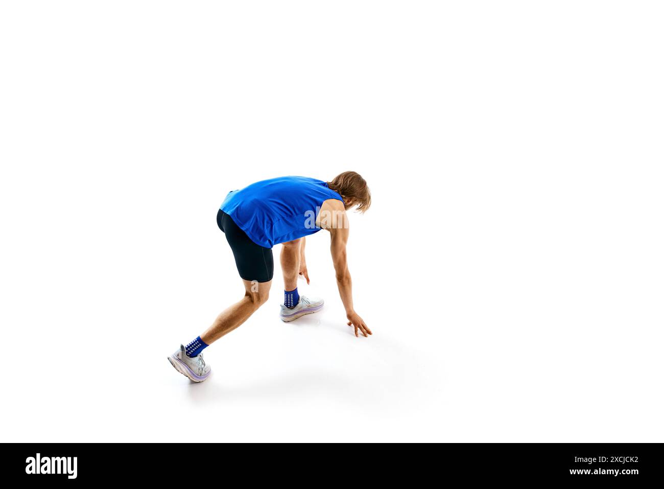 Ready, steady, go. Athletic man, runner standing on starting line ...