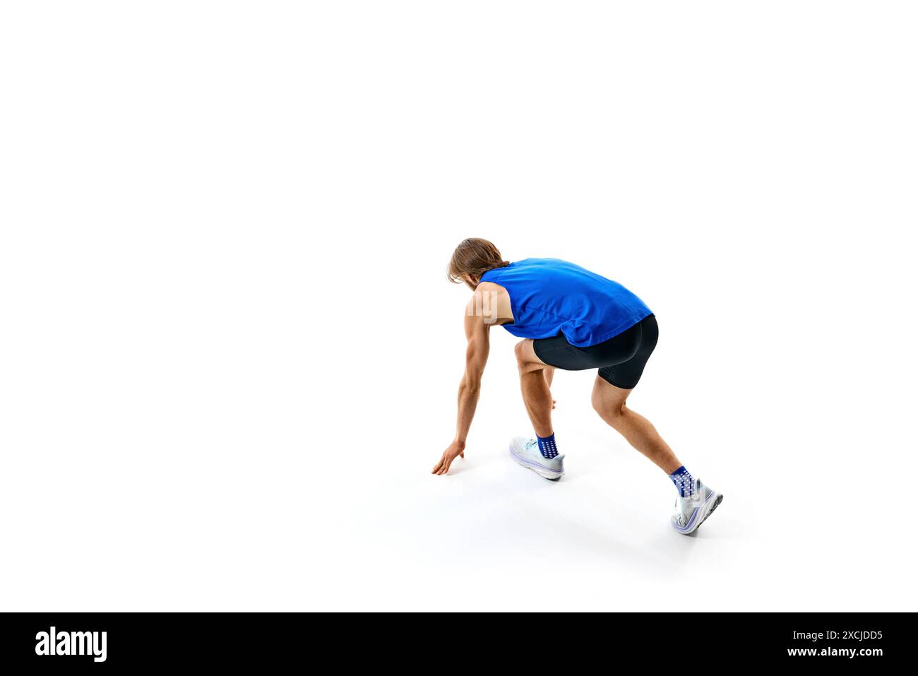 Ready, steady, go. Athletic man, runner standing on starting line ...