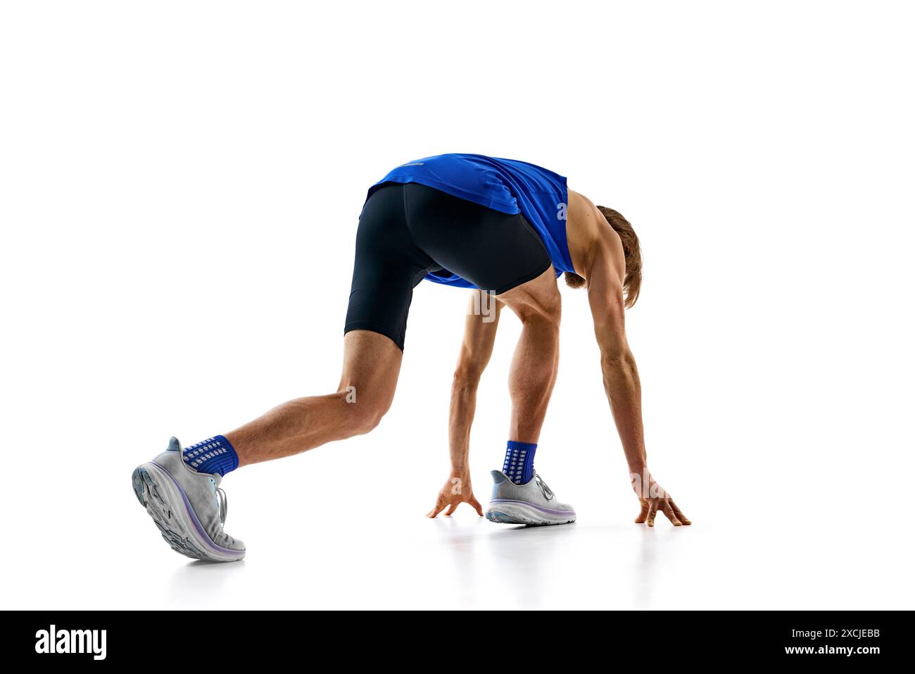 Ready, steady, go. Athletic man, runner standing on starting line ...