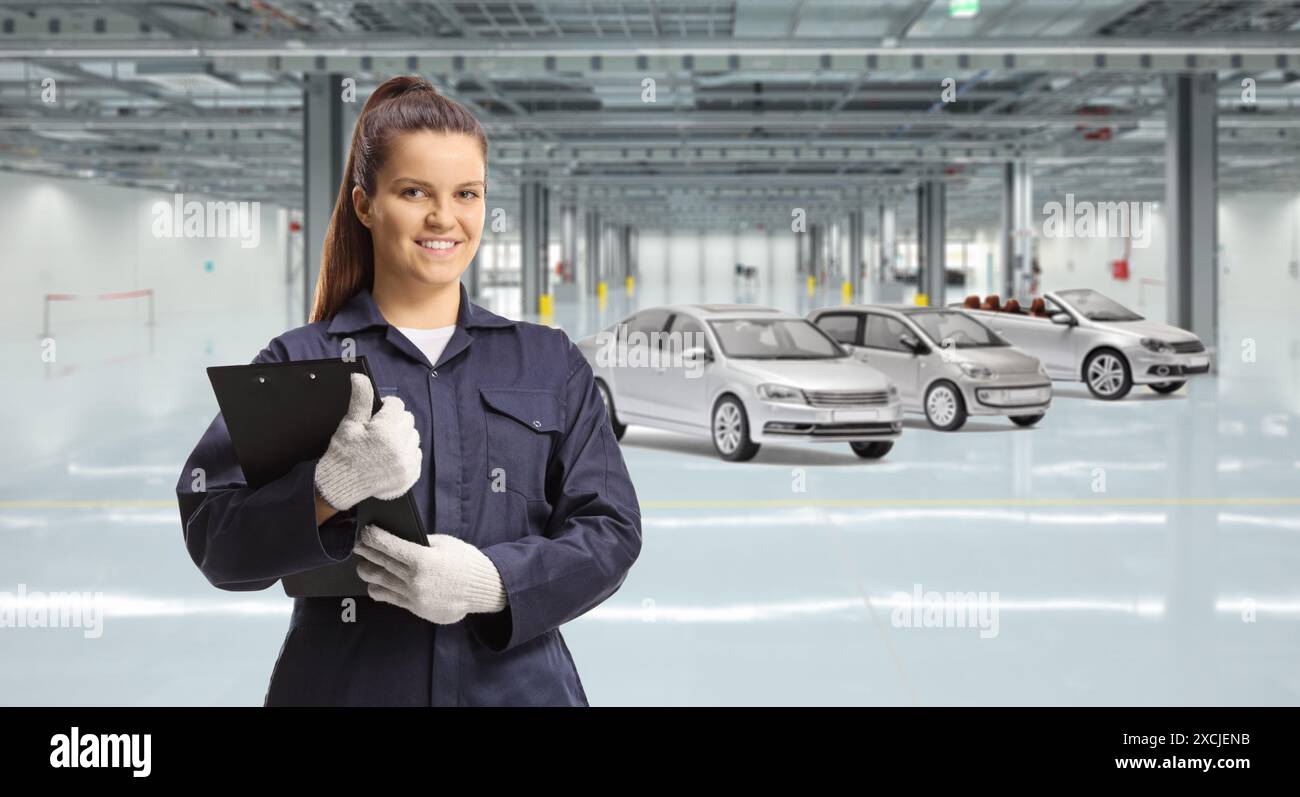 Female mechanic in a uniform standing in a car garage Stock Photo - Alamy