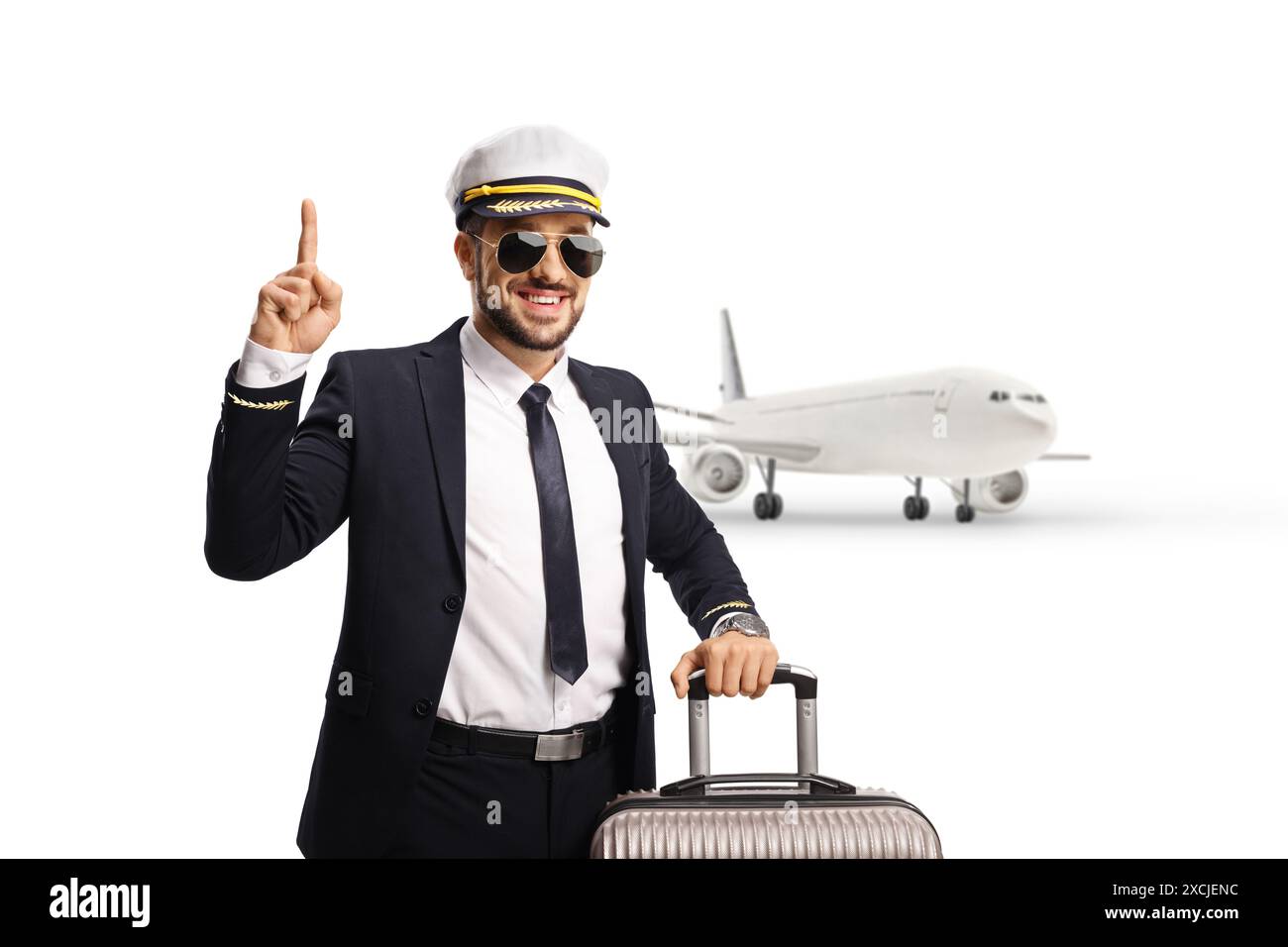 Pilot with a suitcase pointing up at the airport isolated on white ...