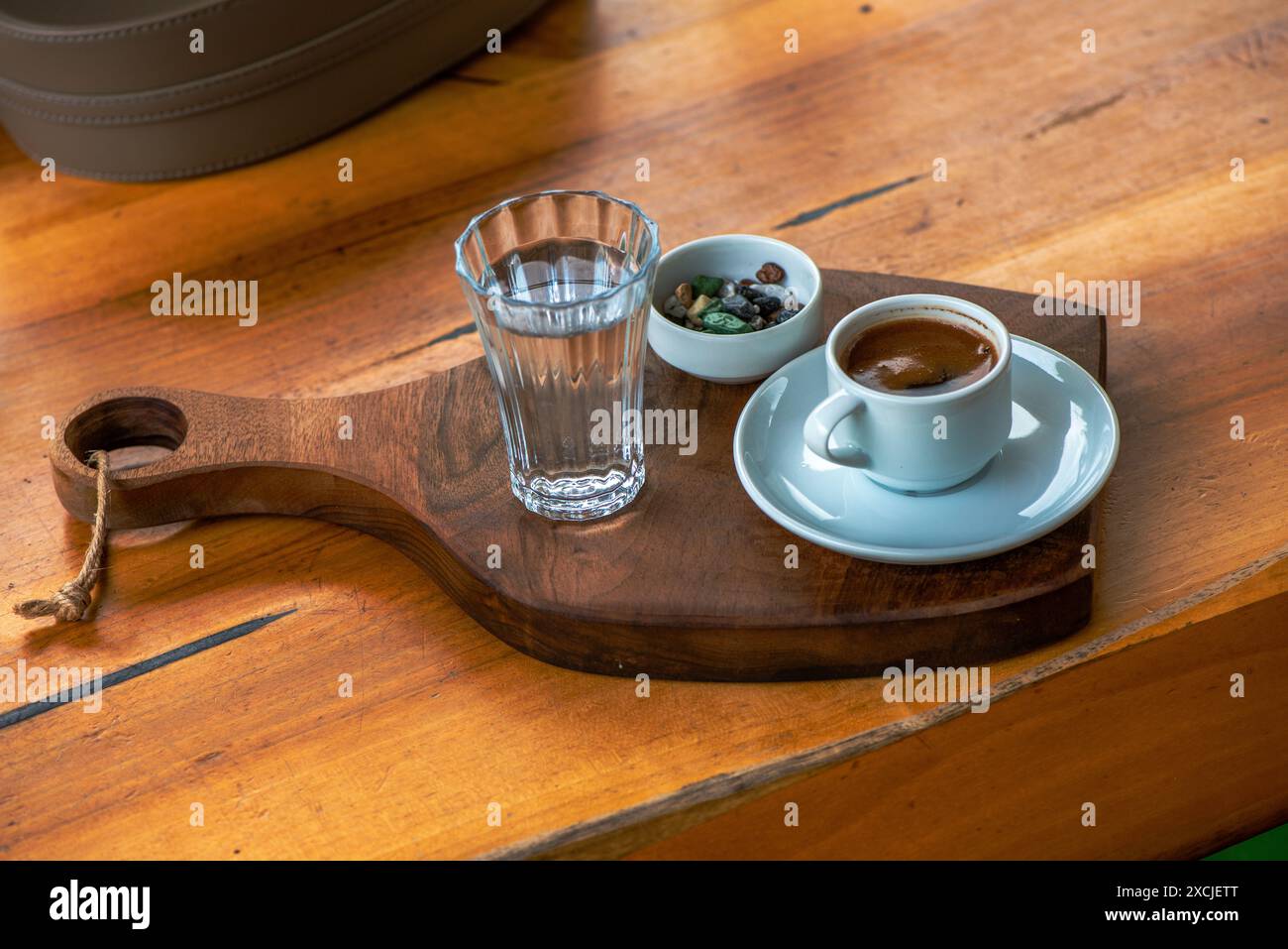 Turkish coffee presentation with pebble chocolate and a glass of water ...