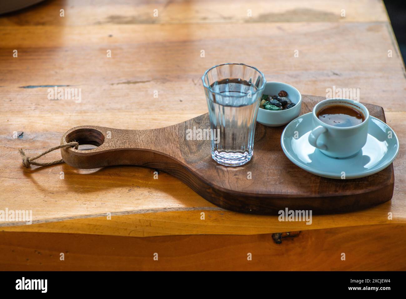Turkish coffee presentation with pebble chocolate and a glass of water ...
