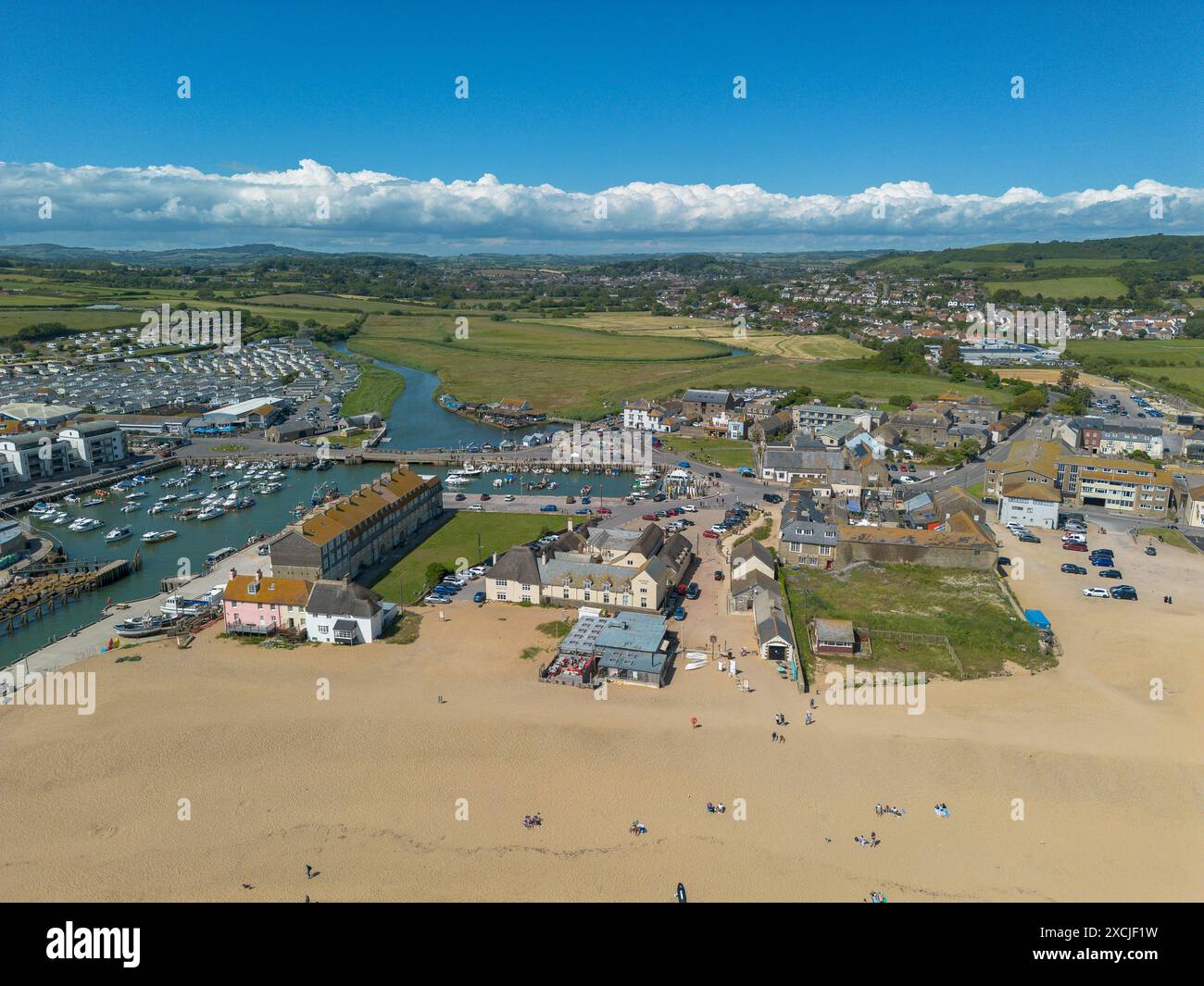 West Bay, Dorset, UK. 17th June 2024. UK Weather. Aerial view of the beach and harbour at the ...