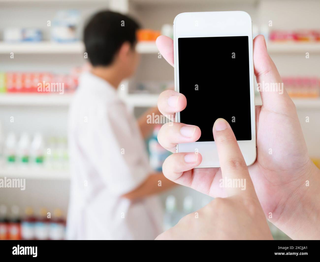women using smart phone in pharmacy blurred background, Pharmacist ...