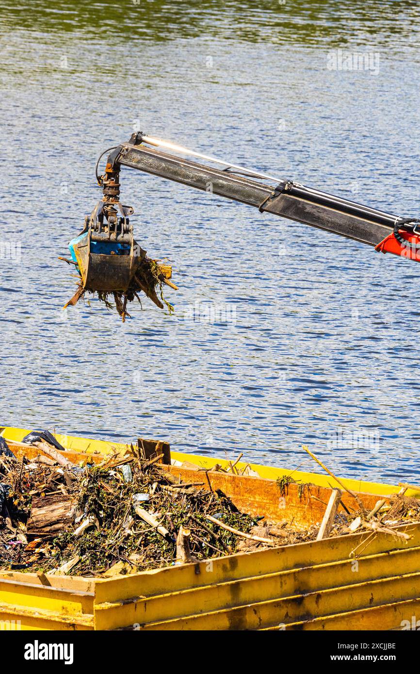 dredger cleans the bottom of the pond. excavator cleans the river ...