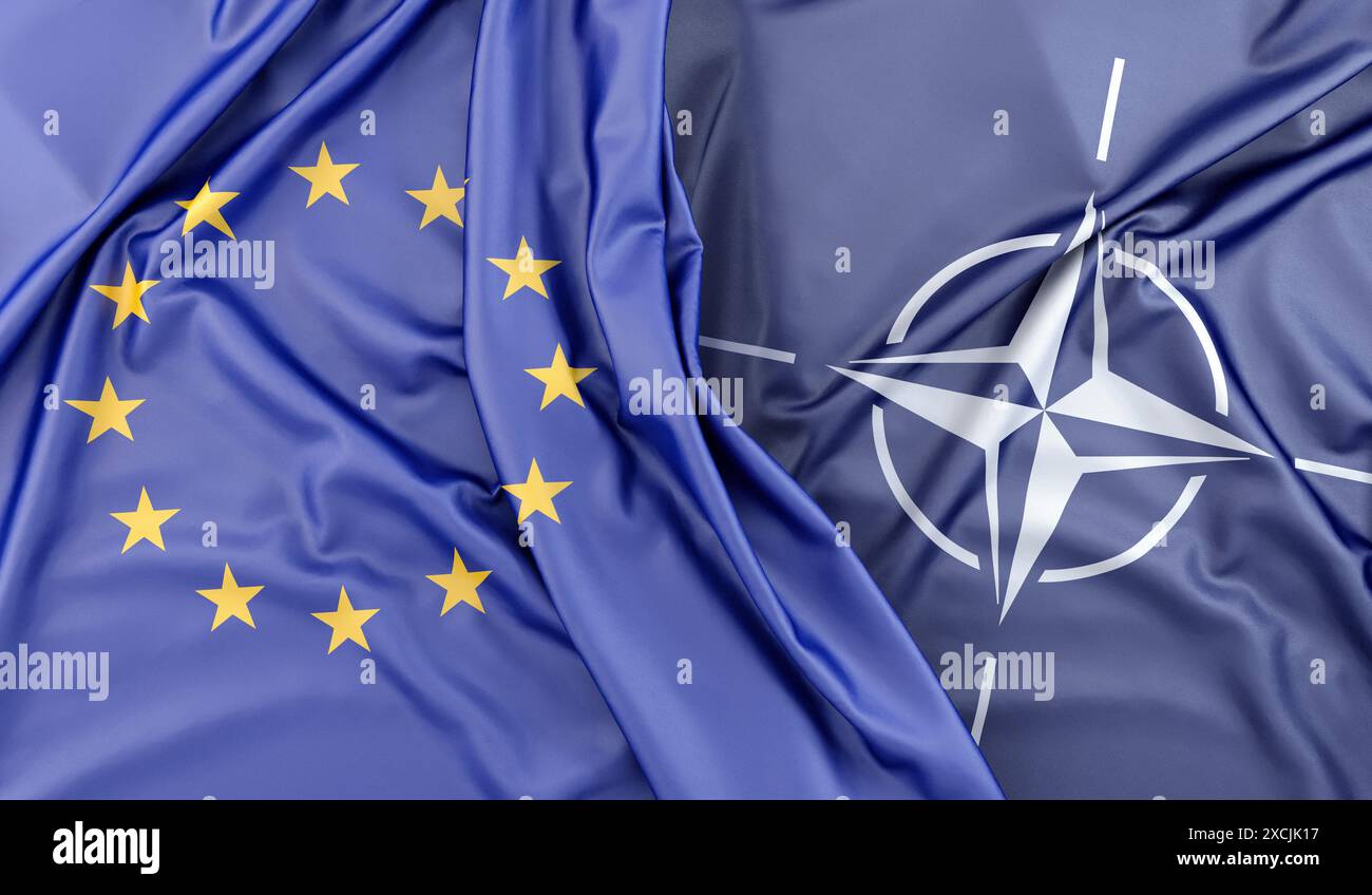 Fabric flags of the European Union and NATO are waving, showing a ...