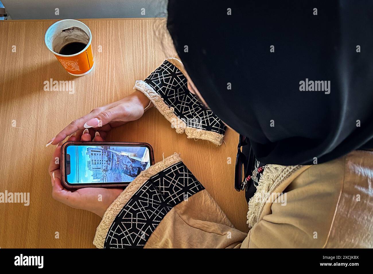 27 May 2024, Egypt, Cairo: A Palestinian woman looks at a photo of the ...