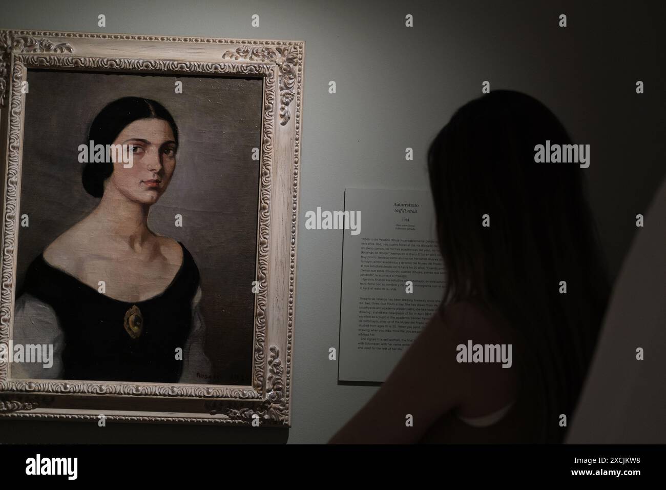 A group of visitors look at images during the inauguration of the ...