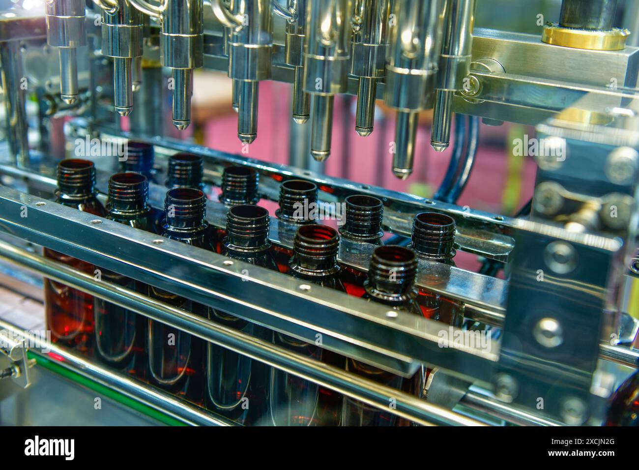 Glass bottles in a conveyor belt on a high quality automatic vertical ...