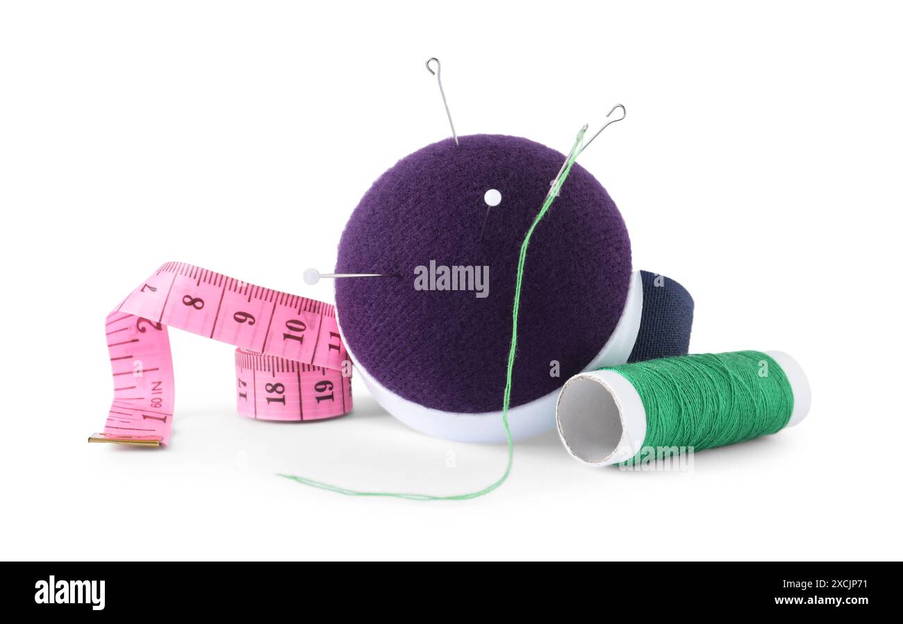 Pincushion, sewing needles, pins, spool of thread and measuring tape ...