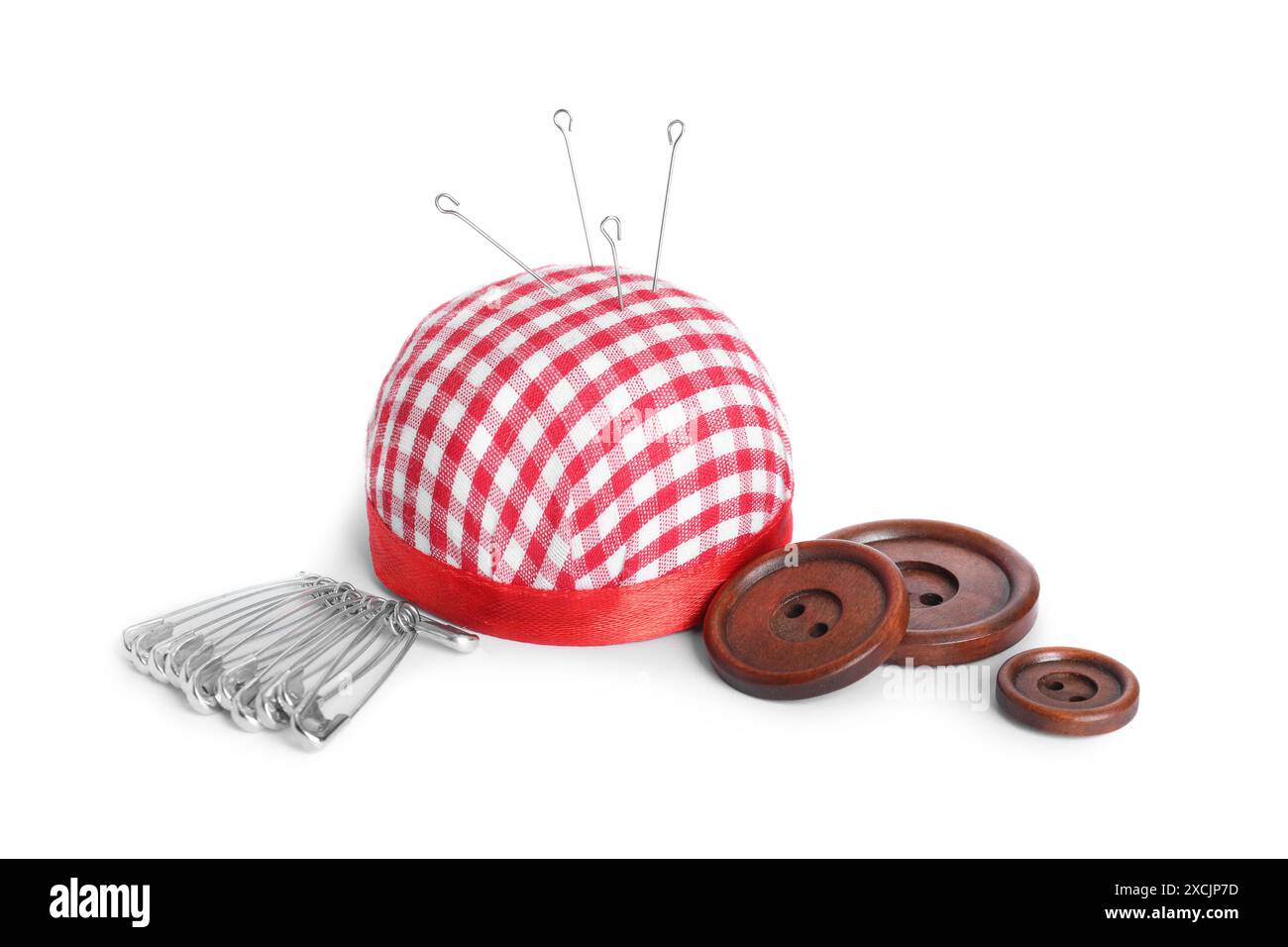 Pincushion, sewing needles, safety pins and buttons isolated on white ...
