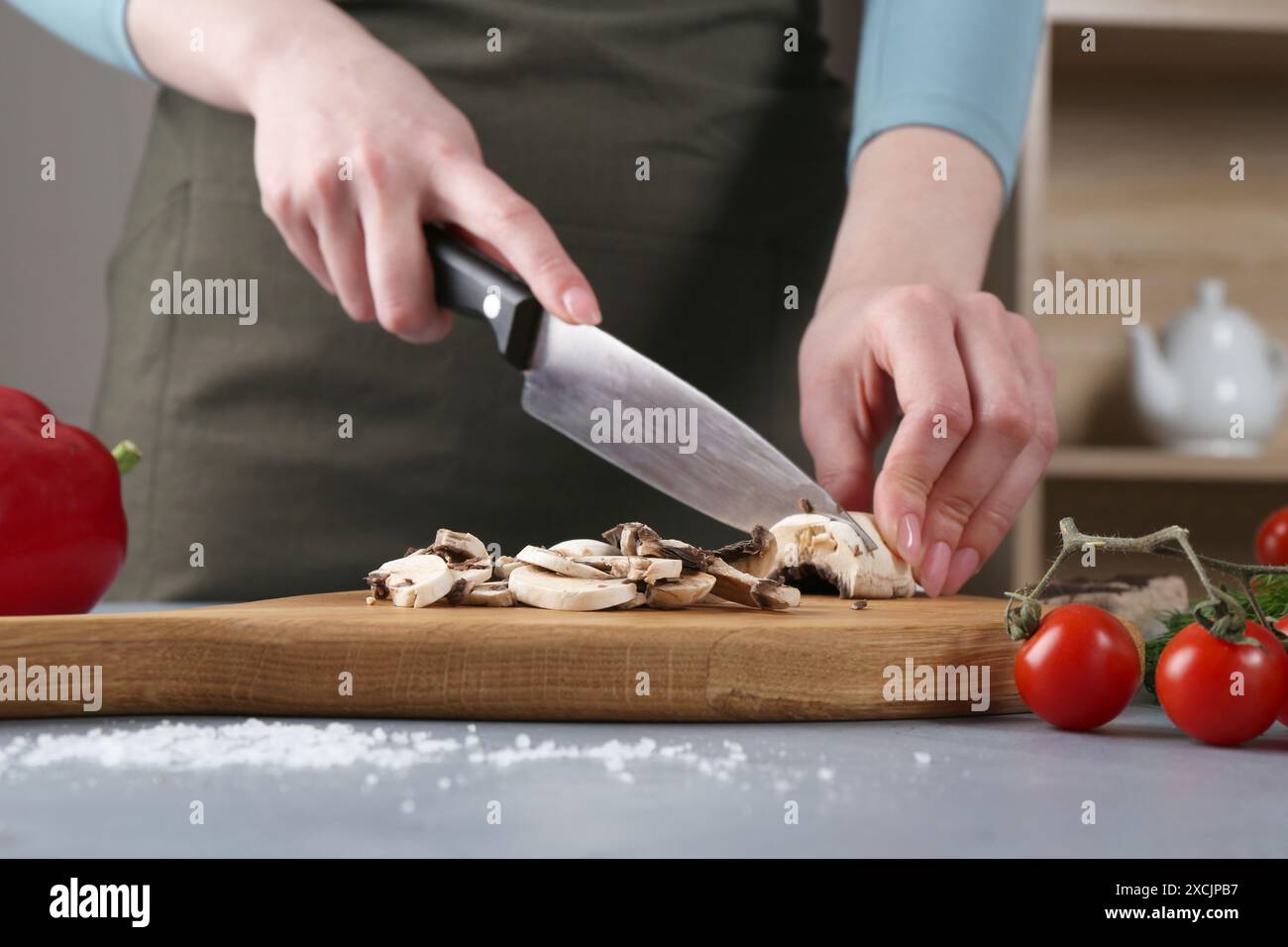 Healthy food. Woman cutting champignon at grey table, closeup Stock ...