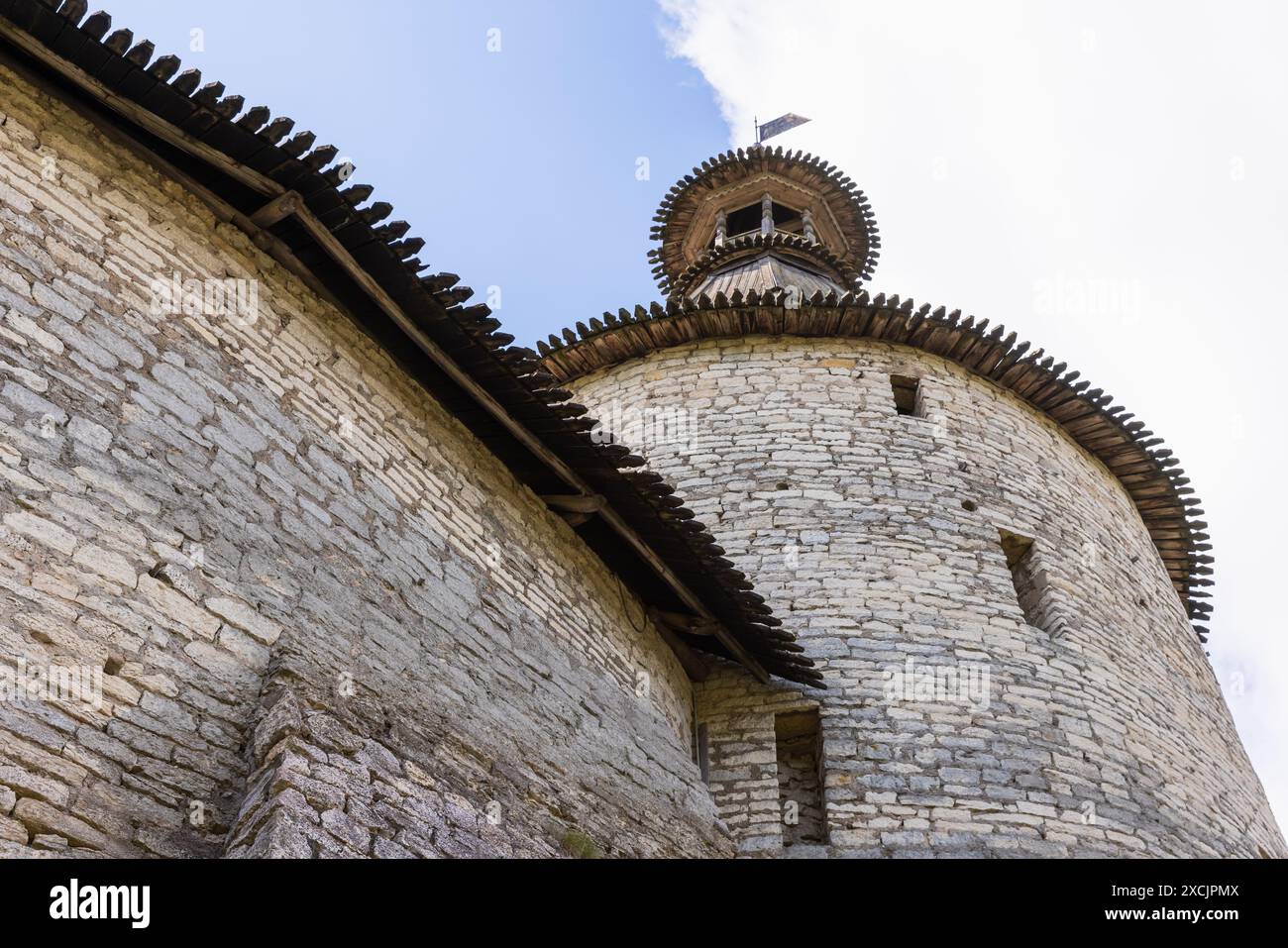Stone fortress tower and walls with wooden roofs. Kremlin of Pskov ...