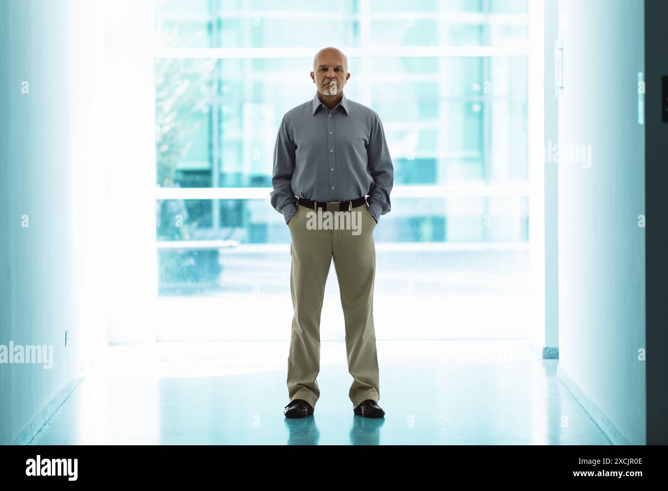 Full body portrait of a senior business executive standing in the ...