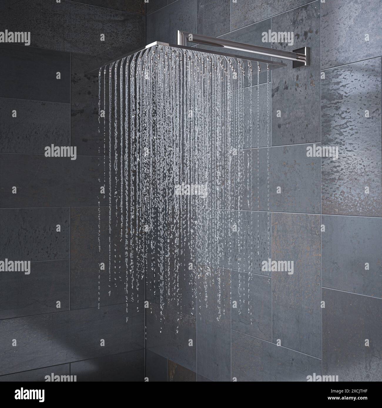 Modern shower head is spraying water in a grey tiled bathroom Stock ...