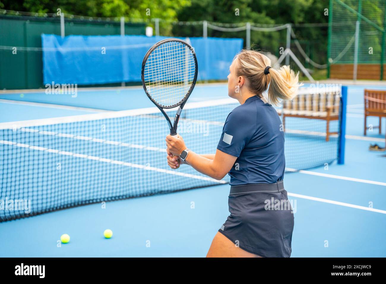 Professional female tennis player playing the tennis on outside court ...