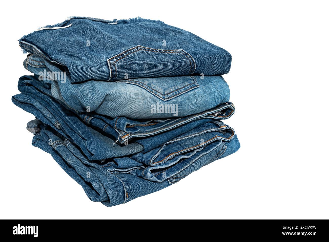 Stack of different jeans on a white background. Denim background ...