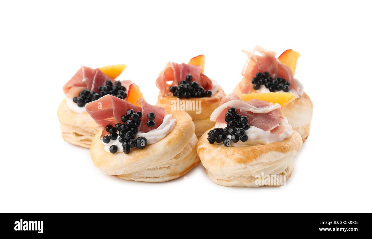 Delicious puff pastry with cream cheese, ham, black caviar and peach ...